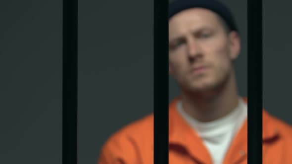 Prisoner With Scars on Face Looking With Confidence on Camera Behind ...