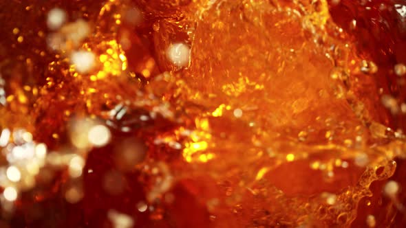 Super Slow Motion Shot of Falling Ice Cubes Into Golden Liquid Vortex ...