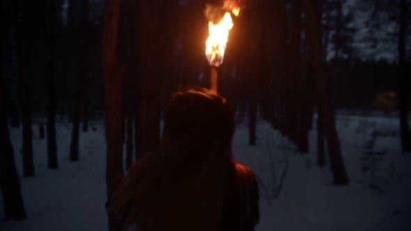 Young Scared Woman with Fire Torch Running From Danger in the Night ...