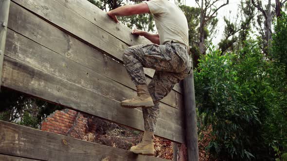 Military soldier climbing a wooden wall at boot camp 4k, Stock Footage