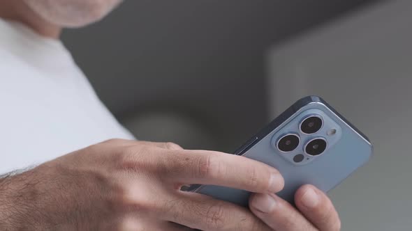 New light blue mobile phone with three camera lenses filmed in close up ...