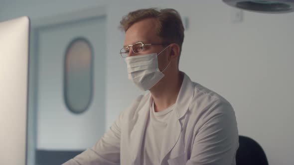 Masked Doctor Watching Monitor in Clinic Close Up, Stock Footage ...