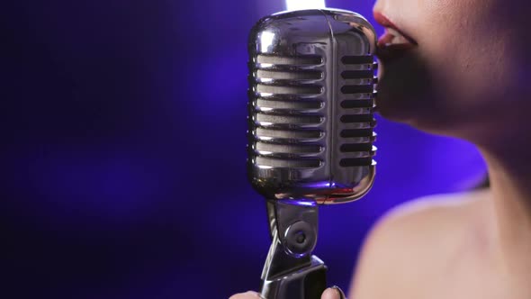 Woman Singer Singing on Microphone on Blue Background, Closeup Lips ...