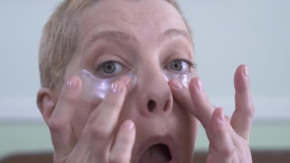 Happy Beautiful Mature Woman Removing Eye Patches and Looking at Camera ...