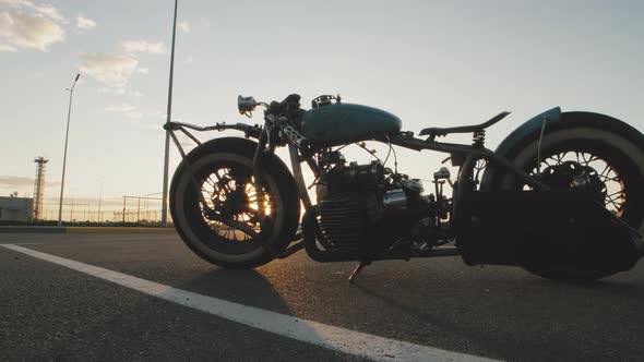 Closeup Dolly Shot of Custom Cafe Racer Motorcycle at Sunset on Street ...