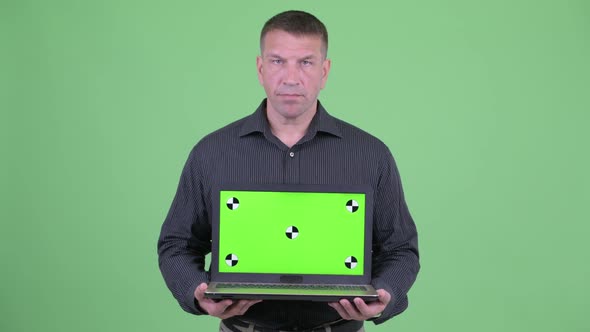 Angry Macho Mature Businessman Showing Laptop, Stock Footage | VideoHive