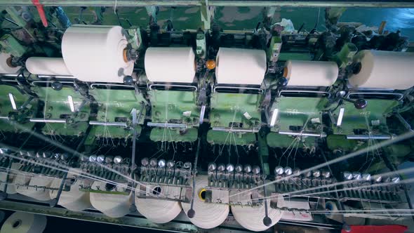 Many Sewing Spools Rotating on a Textile Factory Machine, Stock Footage