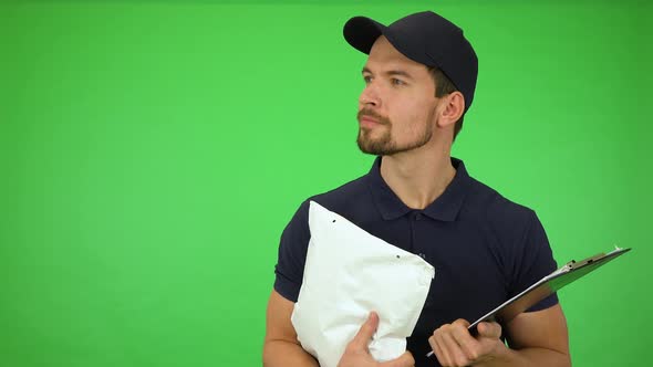 A Young Handsome Mailman Looks Around with a Smile - Green Screen ...