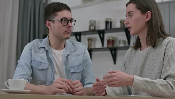 Serious Young Couple Having Conversation in Living Room, Stock Footage