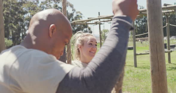 Three diverse fit male and female soldiers taking break, talking at ...