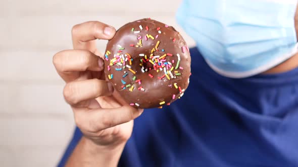 Young Man with Protective Face Mask Holding Donuts, Stock Footage ...