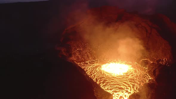 Aerial view of magma coming through a crater fume in the earth surface ...