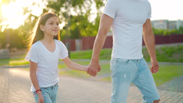 Dad and Daughter Walk Around Their Area at Sunset, Stock Footage ...
