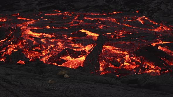 Prehistoric landscape with lava running through black rock. Static view ...