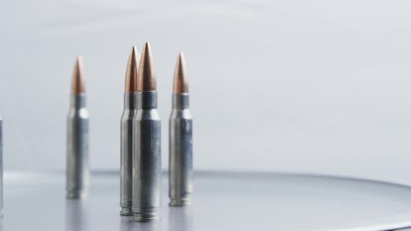 Cinematic rotating shot of bullets on a metallic surface - BULLETS ...