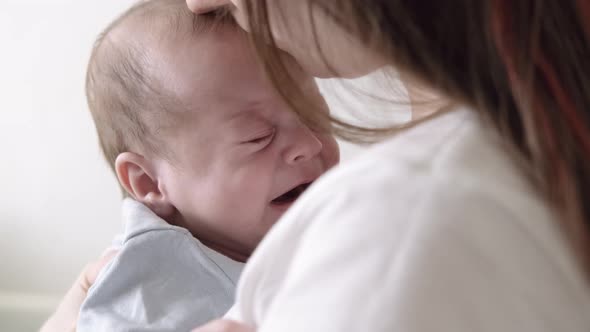 Mommy Tries to Calm the Crying Baby Shakes Him in Her Arms Dissatisfied ...