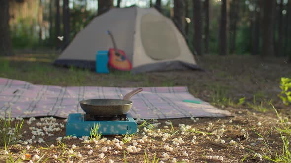 Corn seeds exploding on hot frying pan while cooking pop corn outdoors ...