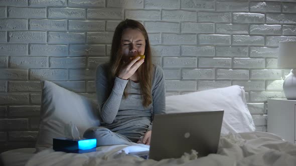 Young Pretty Woman Devouring Donut, Watching Movie, Feeling Lonely and ...