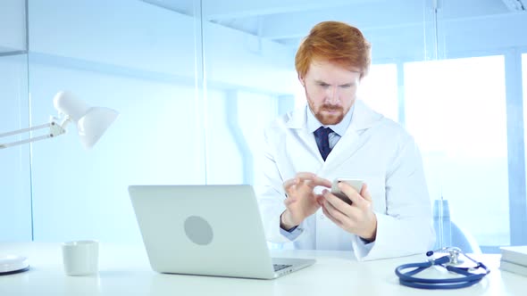 Doctor Browsing Online on Phone in Hospital, Redhead, Stock Footage