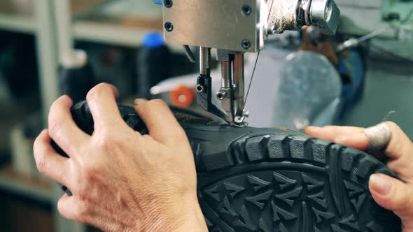 Shoemaker Attaching Sole To a Shoe at a Footwear Facility. Close Up ...