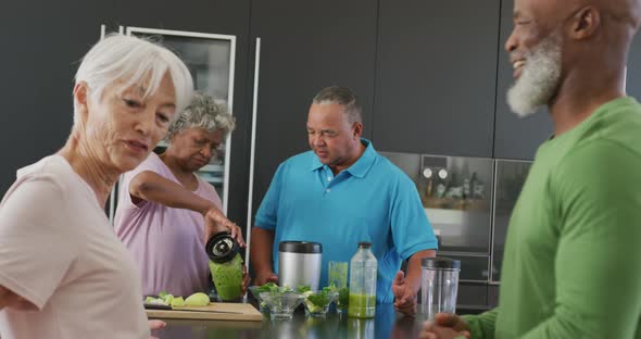 Happy senior diverse people cooking in kitchen at retirement home ...