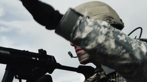 Close up of a soldier firing sub-machine gun, also fixing jammed round ...