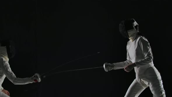 Side View of Professional Fencers Demonstrating Mastery of Foil Fencing ...