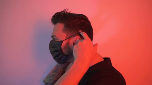 Side View of Young Man Putting Black Face Mask. Hands Put Face Mask Ear ...