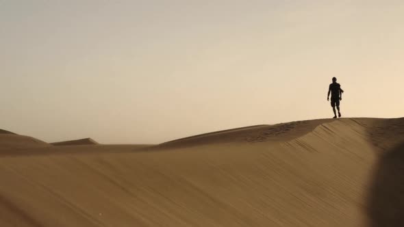 Man Walking Along Sand Dune In Desert, Stock Footage | VideoHive