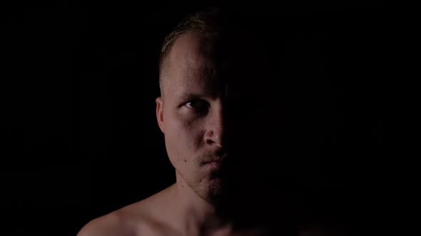 Angry Man in the Dark. Only Half of the Face Is Highlighted., Stock Footage