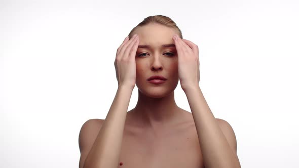 Beautiful Woman Rubs Forehead with Two Hands Rubbing Cosmetics White ...