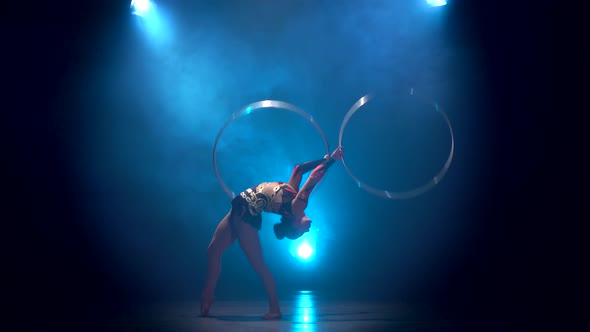 Acrobat Movements with Hoops. Blue Smoke Background, Stock Footage