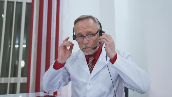 Telemedicine. Doctor putting on headphones, Stock Footage | VideoHive