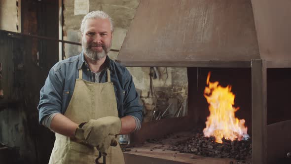 Portrait of Cheerful Blacksmith by Forge, Stock Footage | VideoHive