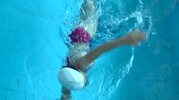 Swim Finish. Slow Motion of Young Woman Swimmer Practicing Freestyle in ...