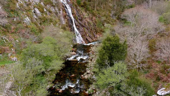 Aerial drone shot over water flowing into the Sor River at the ...
