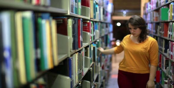 Female Student Wandering Between Shelves, Stock Footage | VideoHive
