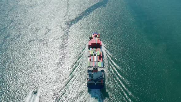Aerial View of a Small and a Huge Merchant Vessels Sailing Across the ...