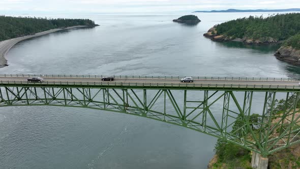 Drone perspective of cars driving across the massive bridge at ...