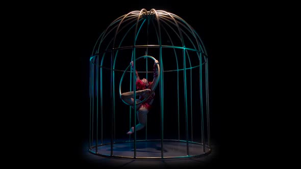 Girl Art Acrobatics on a Spinning Hoop in a Cage, Black Background ...