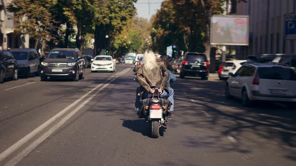 Two Women Riding Motorcycle By the City Street Rear View, Stock Footage