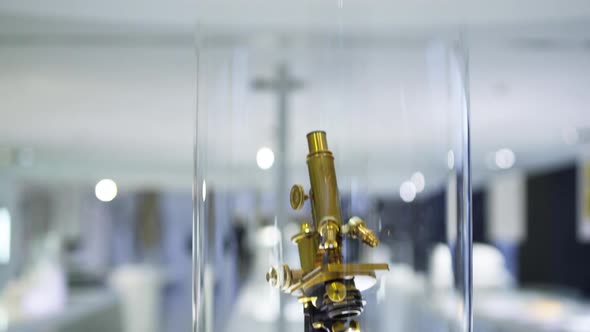 Pan down to an ancient microscope model made from brass, being ...