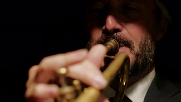 Closeup of Face of Man in Hat Playing Trumpet in Spotlight Front View ...
