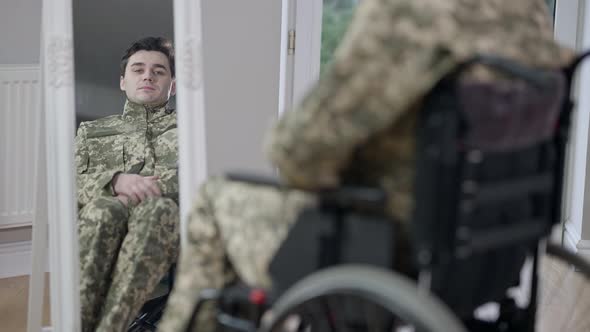 Reflection in Mirror of Young Paraplegic Man in Wheelchair Adjusting ...