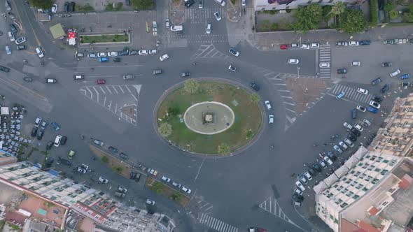 Slow aerial top down overhead footage of roundabout in a neighborhood ...