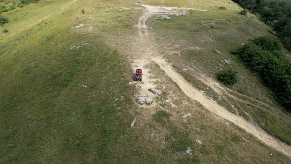 Red ATV with a Driver Stands on the Edge of a Cliff, Stock Footage