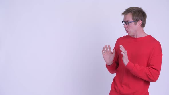 Young Handsome Man Touching Something and Looking Shocked, Stock Footage
