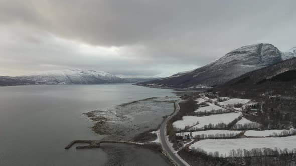 Freezing cold Norwegian Arctic landscape, drone view of fjord and snowy ...