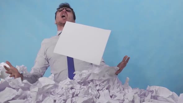 Furious Man Office Worker Leans Out of a Large Heaps of Crumpled Paper ...