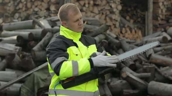 Lumberjack in Reflective Jacket. Man Woodcutter with Electric Chainsaw ...